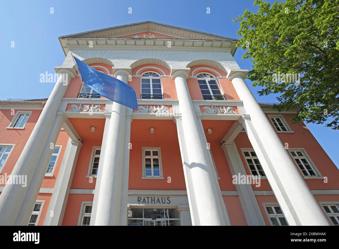 Neoclassical town hall built in 1910 with EU flag, columns and arcade ...