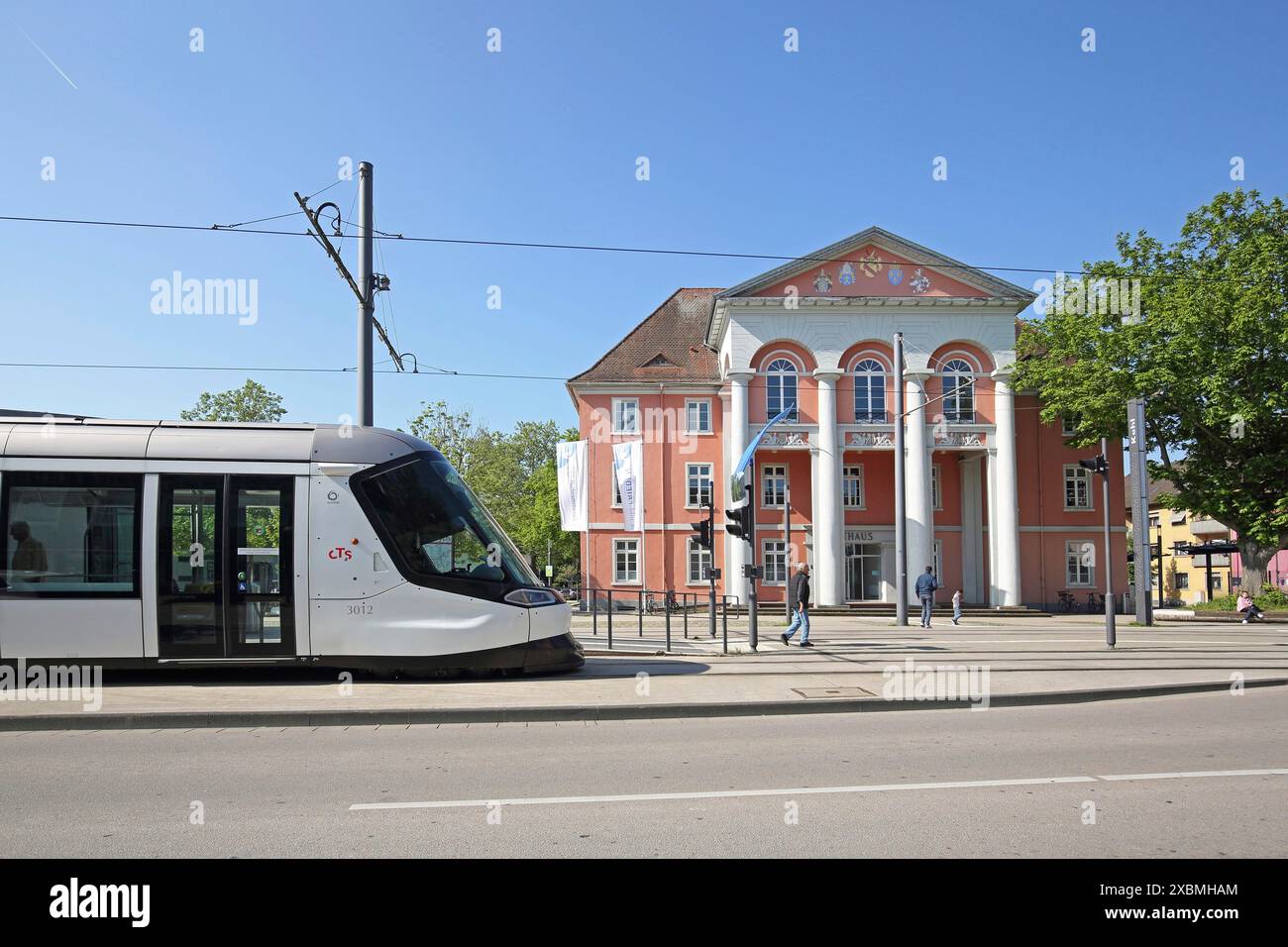 Neoclassicism town hall built in 1910 and tram, tram stop, people ...