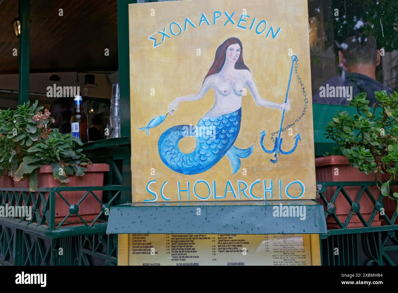 Naively painted sign with mermaid, traditional restaurant Scholarchio ...