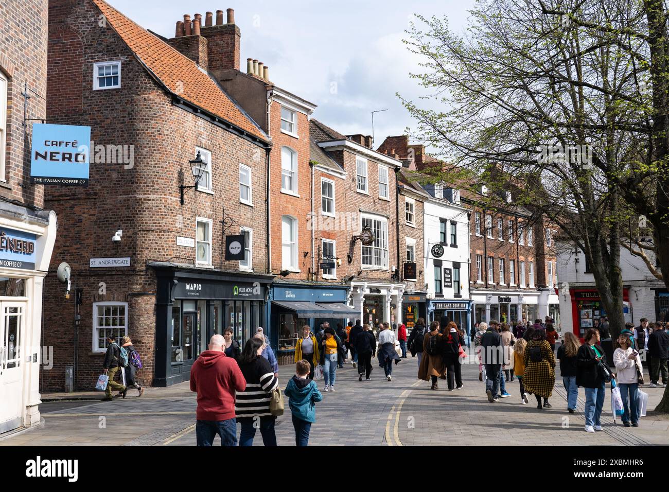 Tourists and shoppers walking on the pedestrianised Colliergate and ...