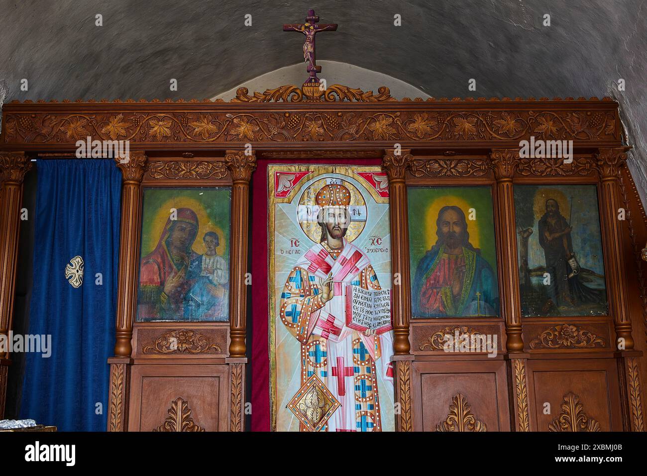 Interior with richly decorated iconostasis and religious images of saints, Kastro Monolithou ...