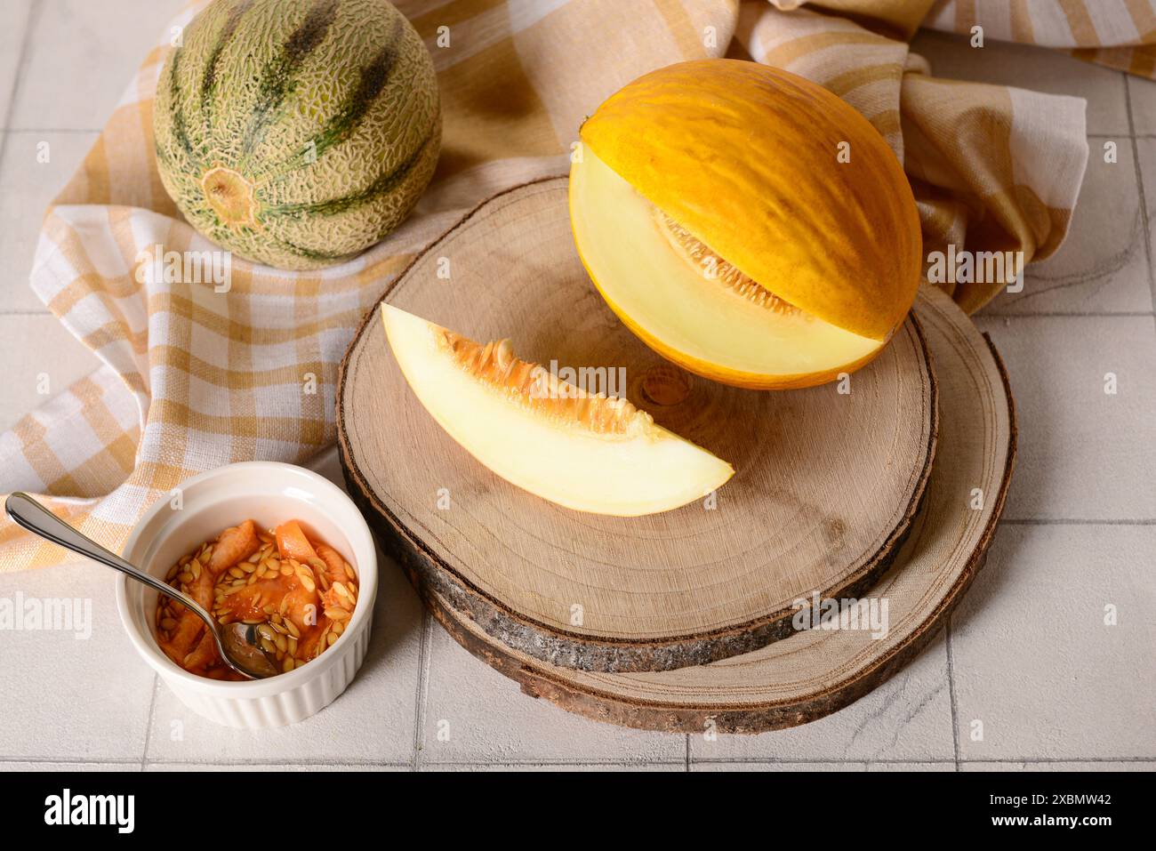Wooden boards with tasty ripe melons on white tile background Stock ...