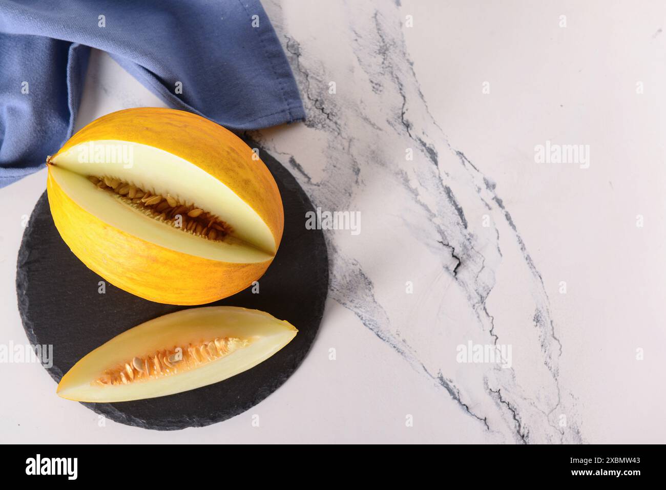 Slate board with tasty ripe melon on white marble background Stock ...