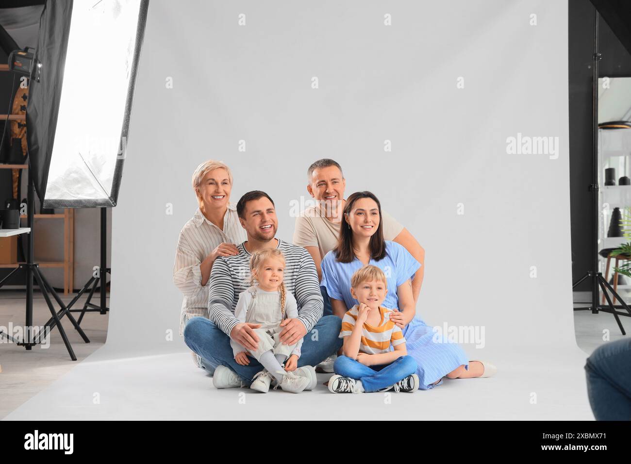 Big family having photo shoot in studio Stock Photo - Alamy