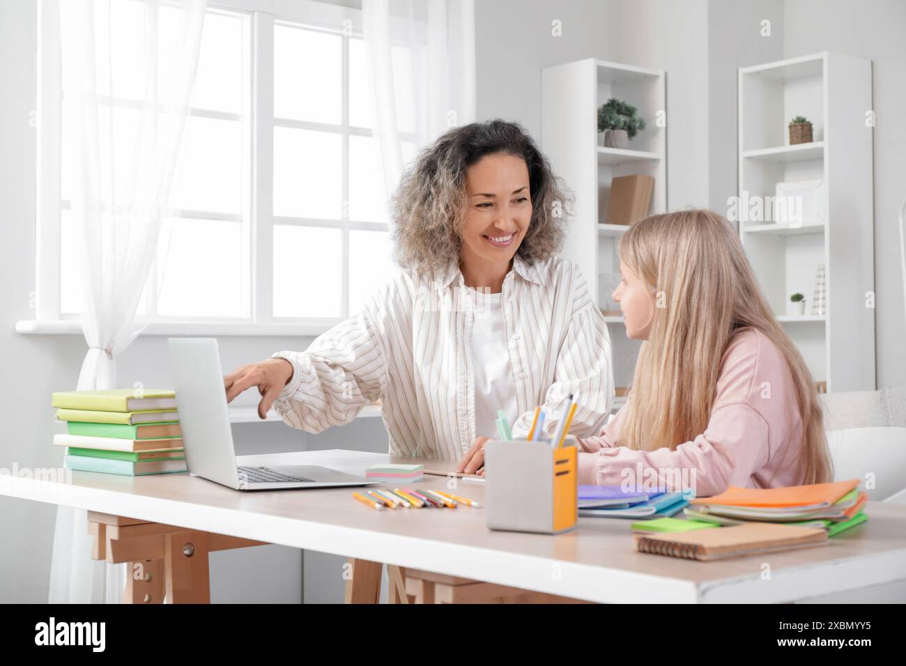 Little girl studying Math with tutor at home Stock Photo - Alamy