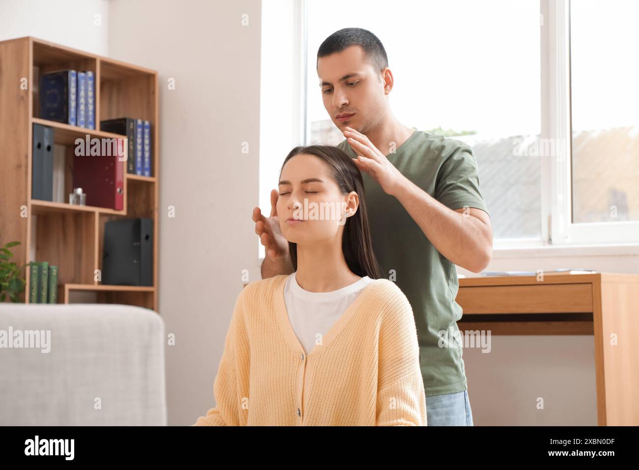 Male psychologist hypnotizing woman in office Stock Photo - Alamy