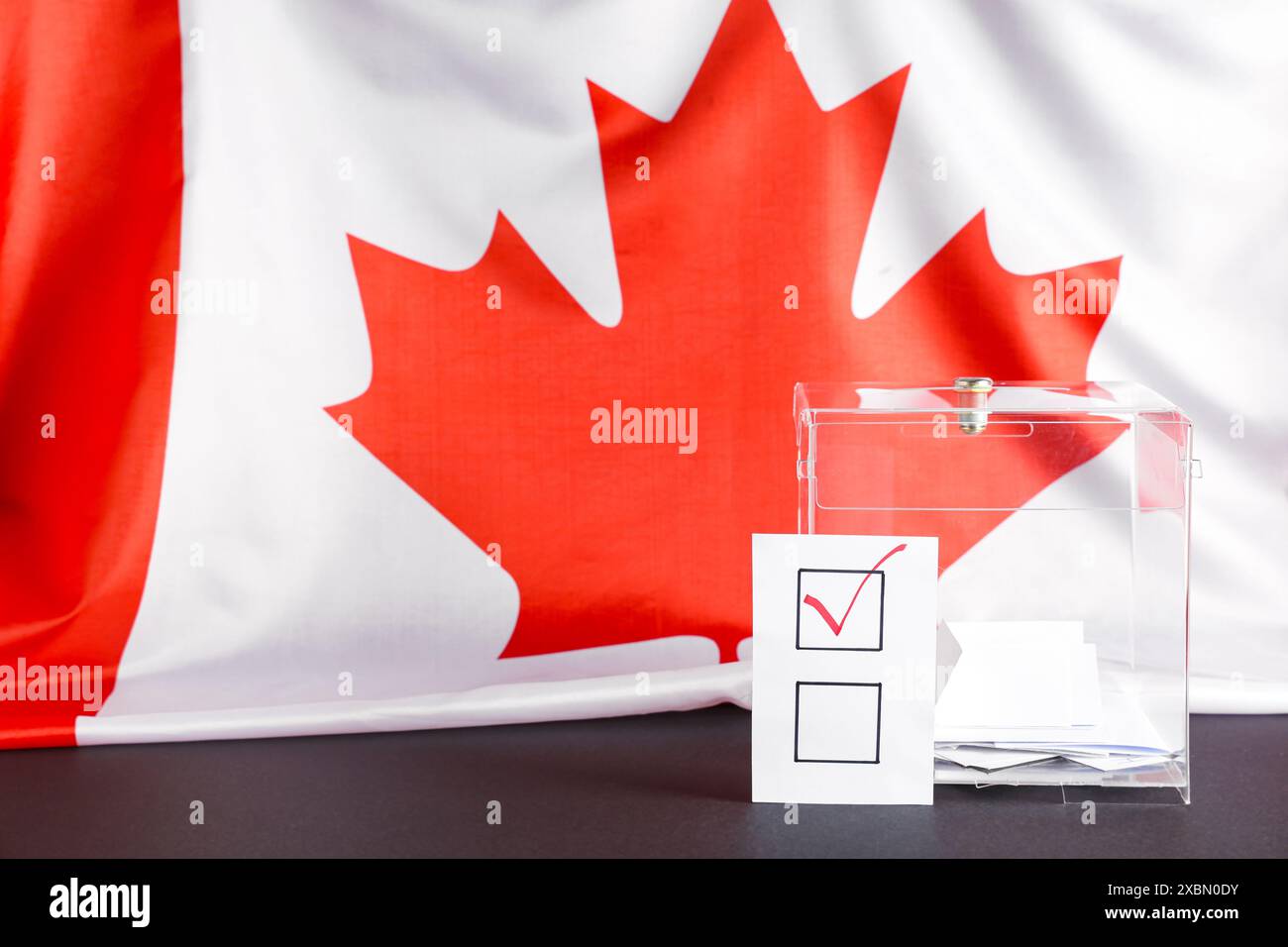 Ballot box on dark table against Canadian flag Stock Photo - Alamy