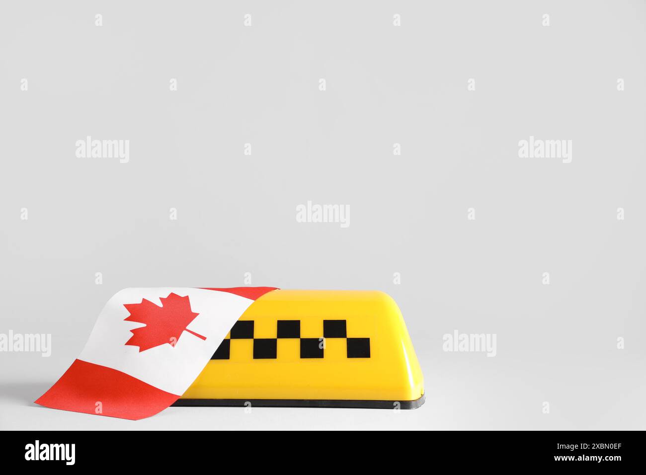 Taxi roof sign with Canadian flag on light background Stock Photo - Alamy
