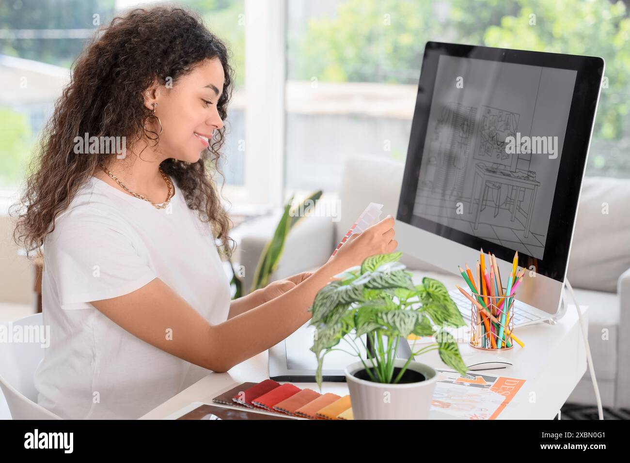 Female African-American graphic designer working with color palettes at ...