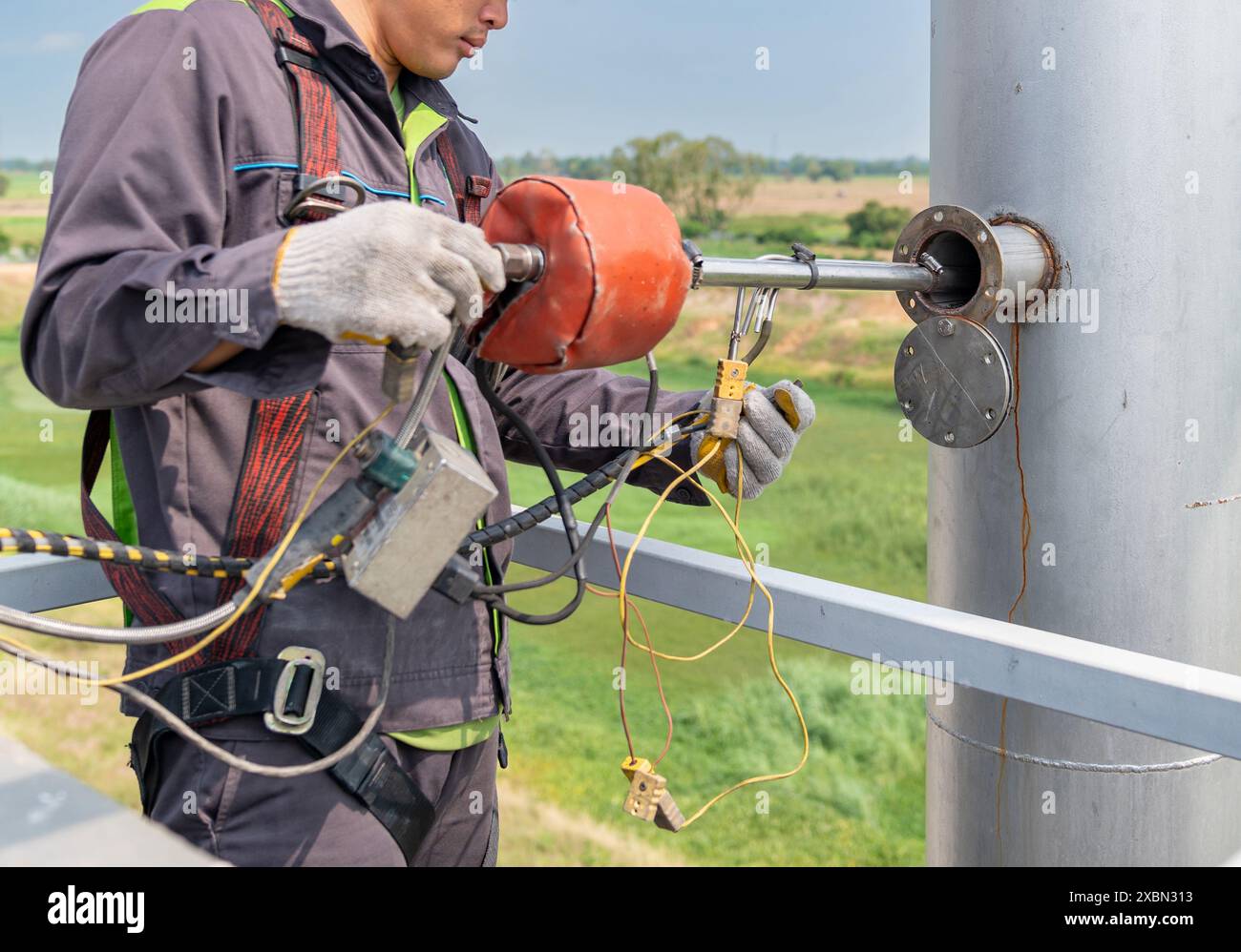 Environment officer sampling pipe for sampling air in stack of boiler ...