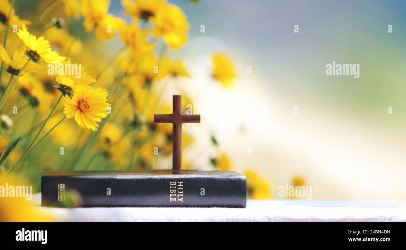 Cross of Jesus Christ, holy bible, beautiful yellow flowers and prayer ...