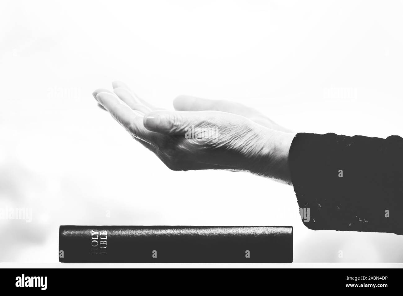 Christian old man praying and worshiping with hands on holy bible ...