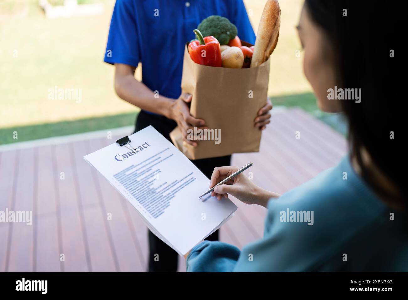 Home Delivery Service Customer Receiving Grocery Package and Signing ...