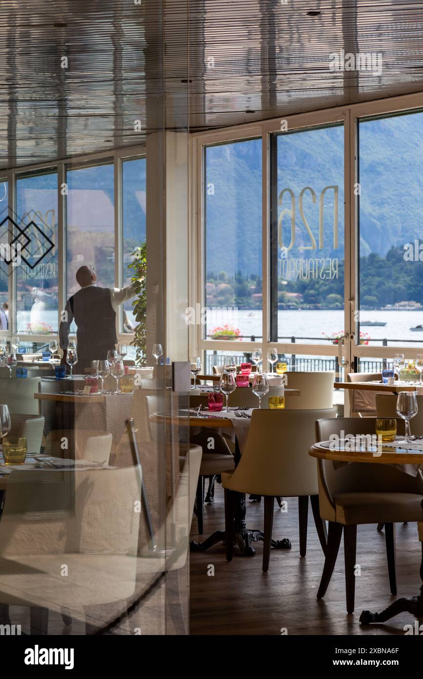 A waiter prepares the dining room at the N26 Restaurant in the Hotel ...