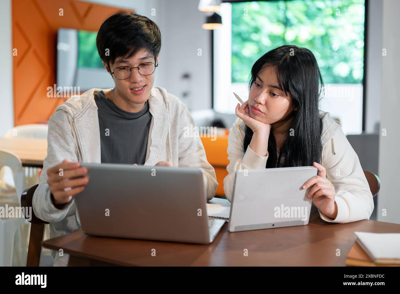 Two students discuss something in hi-res stock photography and images ...