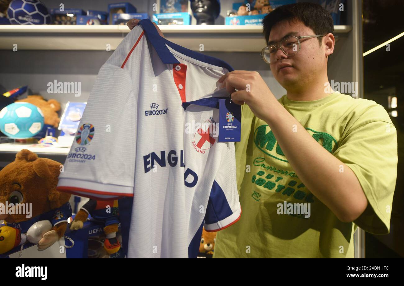 HANGZHOU, CHINA - JUNE 13, 2024 - Customers buy T-shirts of national ...