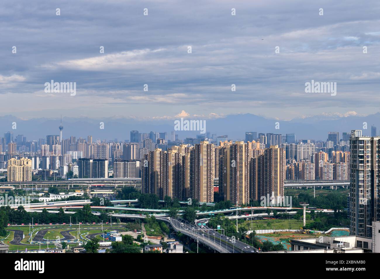 The downtown skyline in the morning with the highest peak of Mount Siguniang background in ...