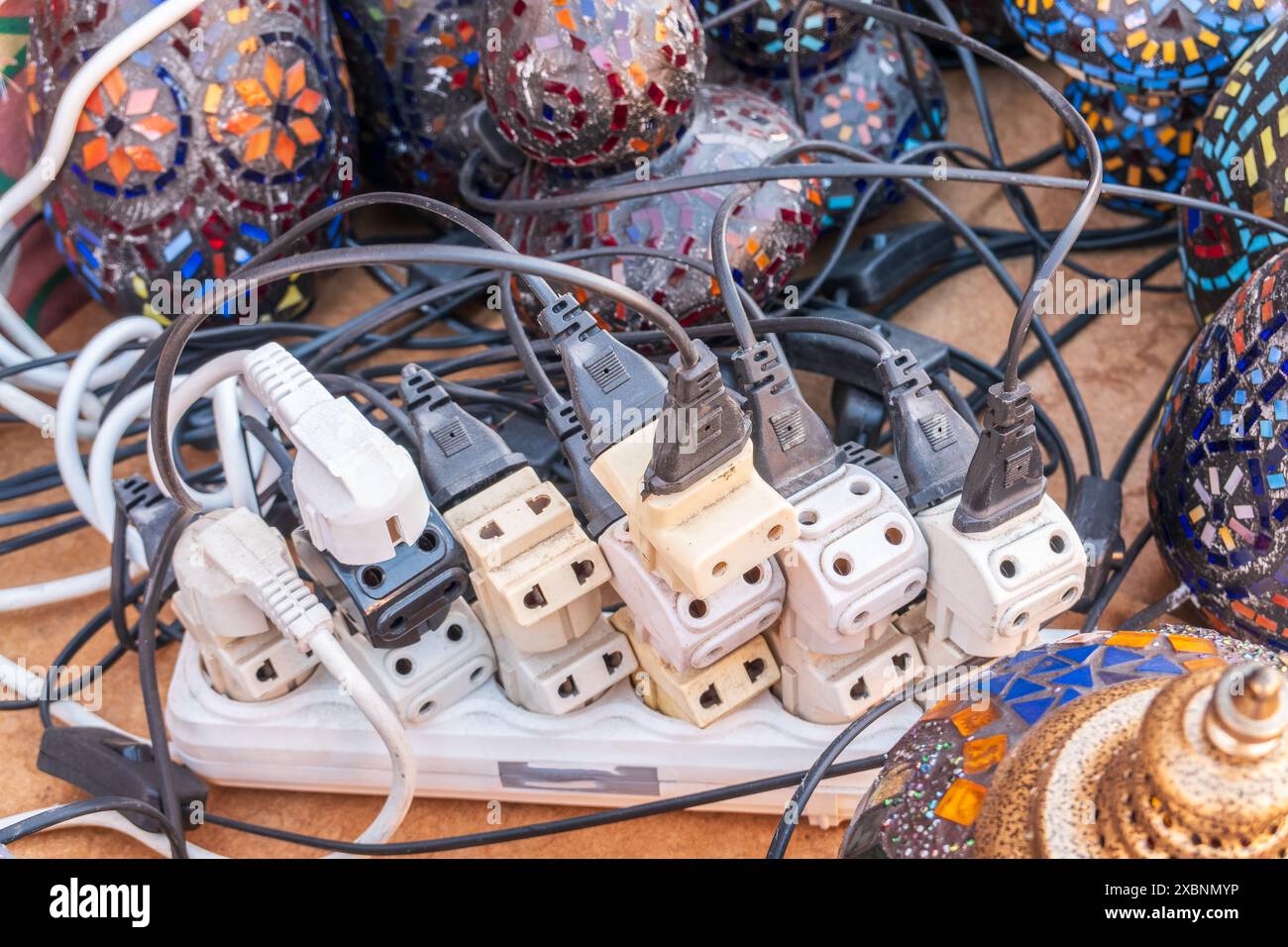 Old and damaged electric adapter power plug has many appliances are ...