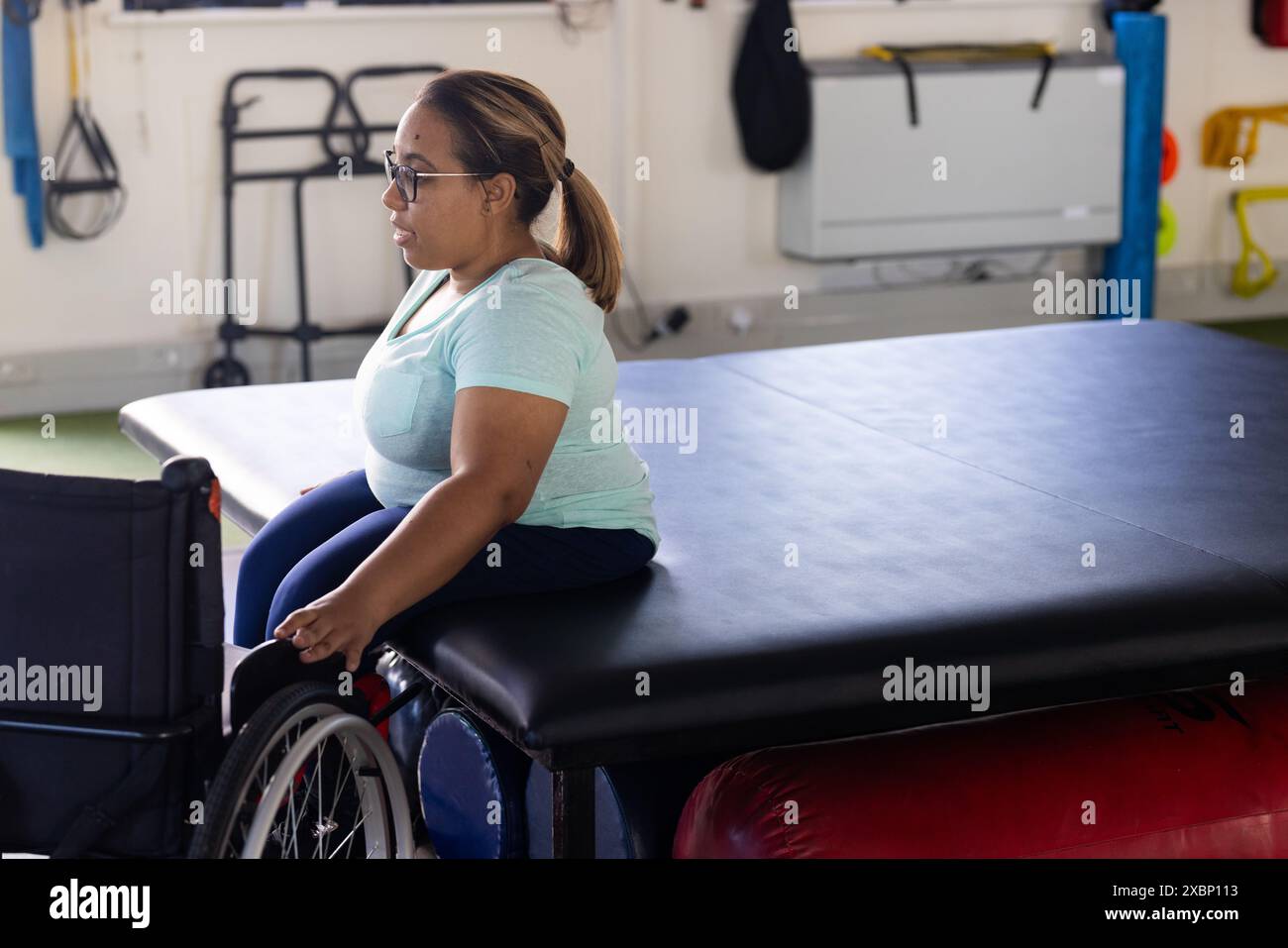 Woman with paraplegia in wheelchair doing rehabilitation exercises ...