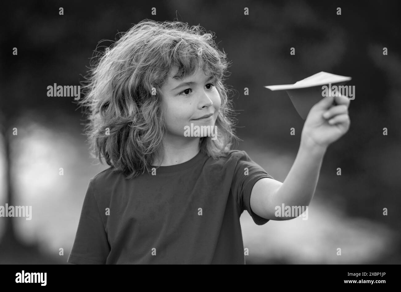 Kid with plane. Child throwing paper plane. Cute blonde child play with ...