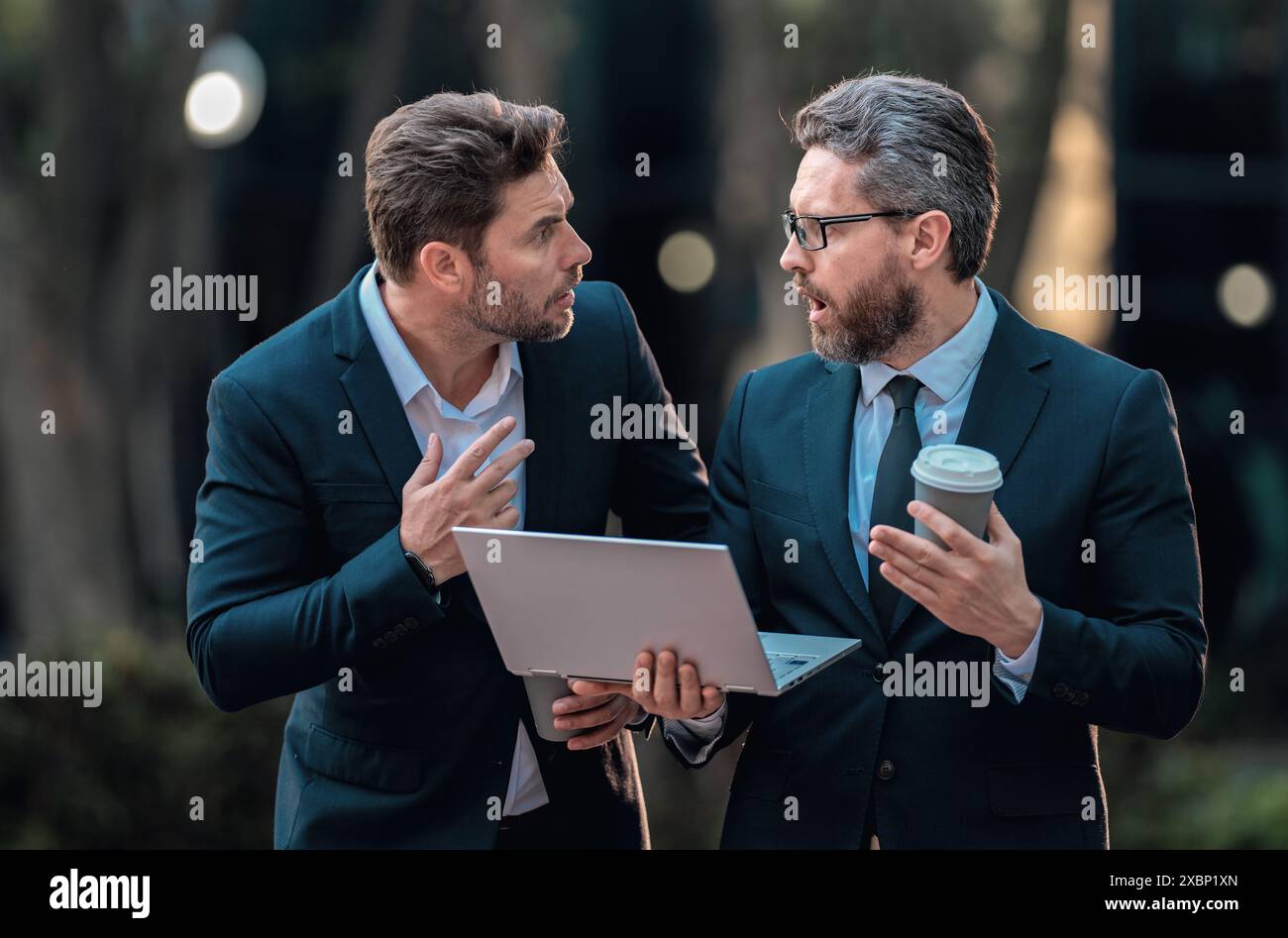Excited suprised two business teams men team using tablet laptop ...