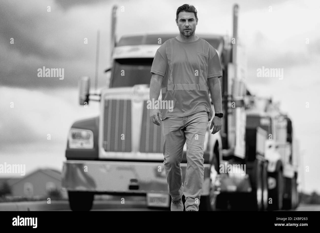 Men driver near lorry truck. Truck driver in safety vest near truck ...