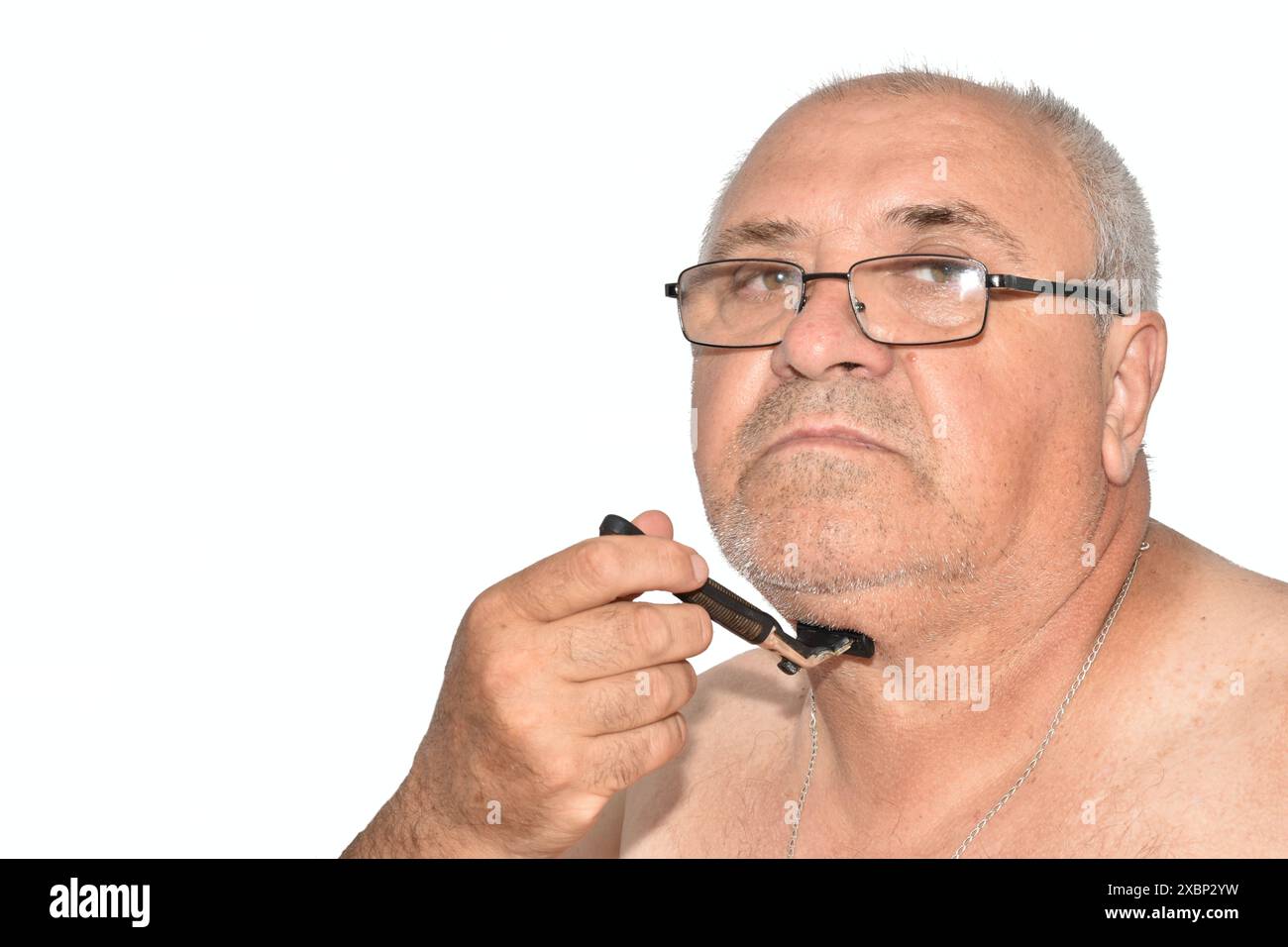 A man tries to shave his neck with a machine Stock Photo - Alamy