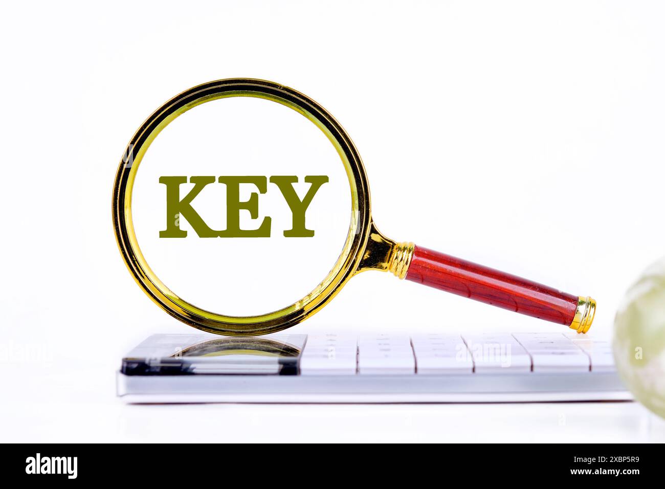 KEY word. Letter KEY written through the lens of a magnifying glass on ...