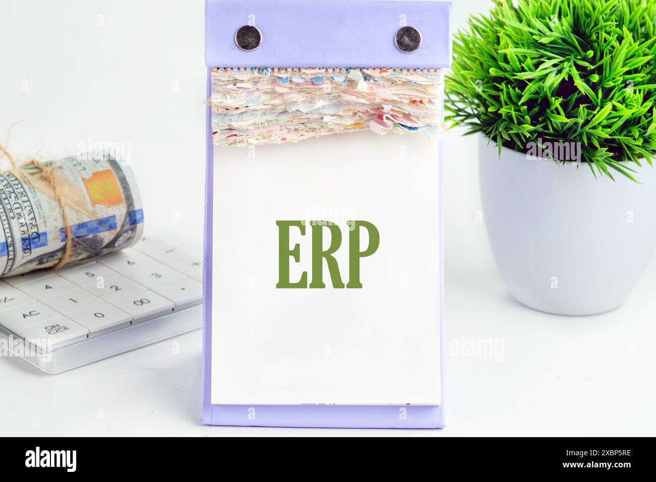 ERP - Enterprise resource planning theme. Concept word ERP in a desktop calendar with dollar ...