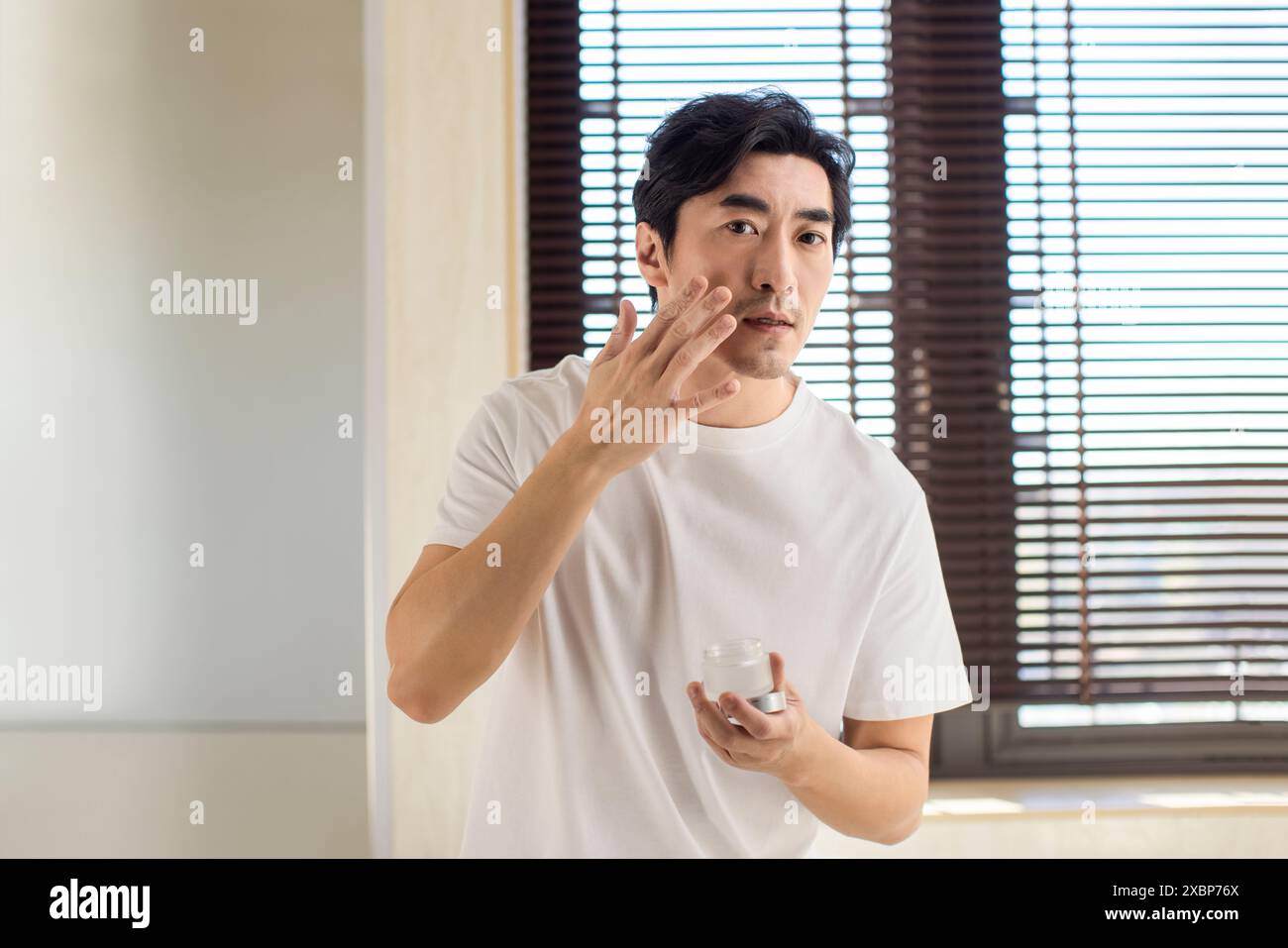 Mature Man Applying Moisturizer Stock Photo - Alamy