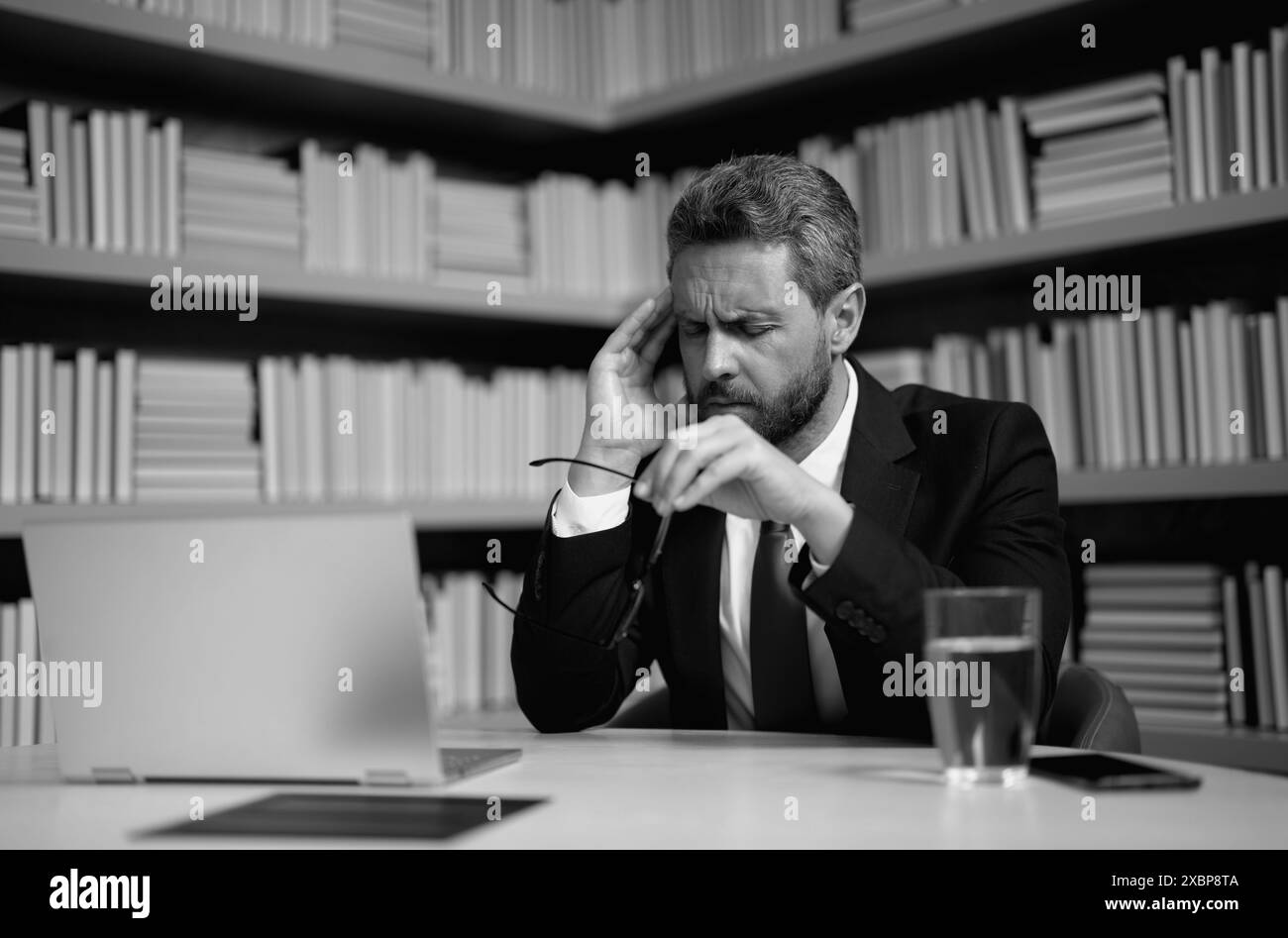 Overworked man feeling migraine head strain. Tired bored man has office ...