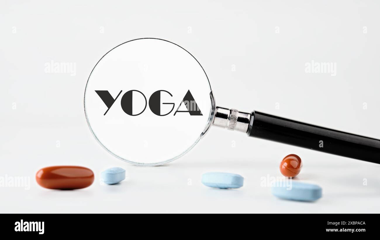 The word YOGA written through a magnifying glass on a light background ...