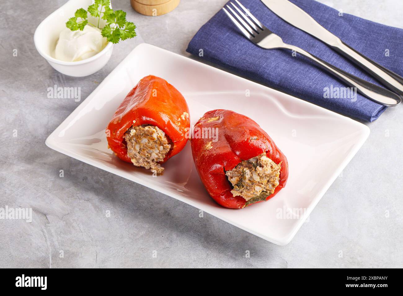 Stuffed bell pepper with minced meat and rice. Served sour cream Stock ...