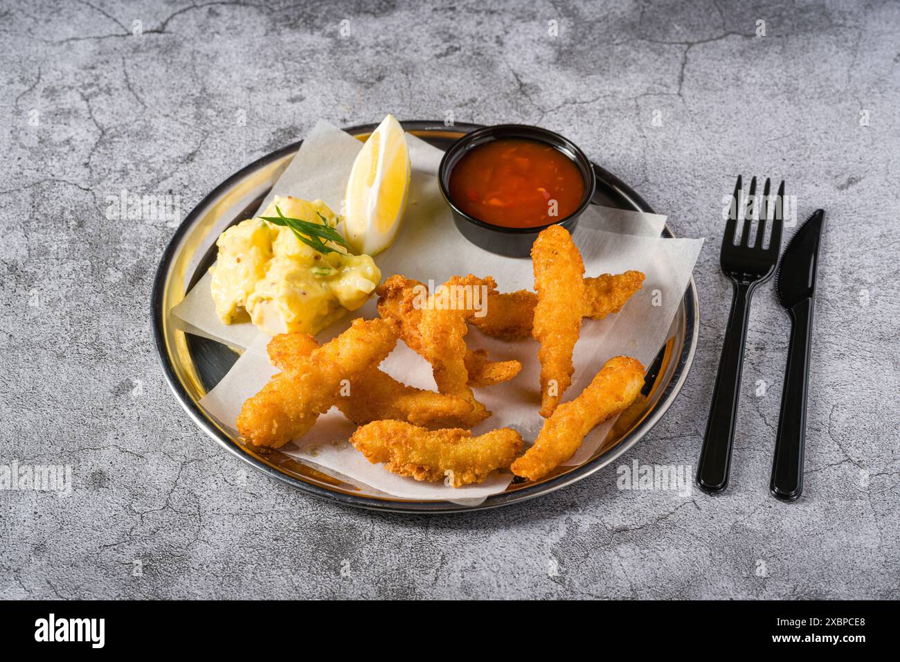 Deep fried shrimp tempura with potato salad on a metal plate Stock ...