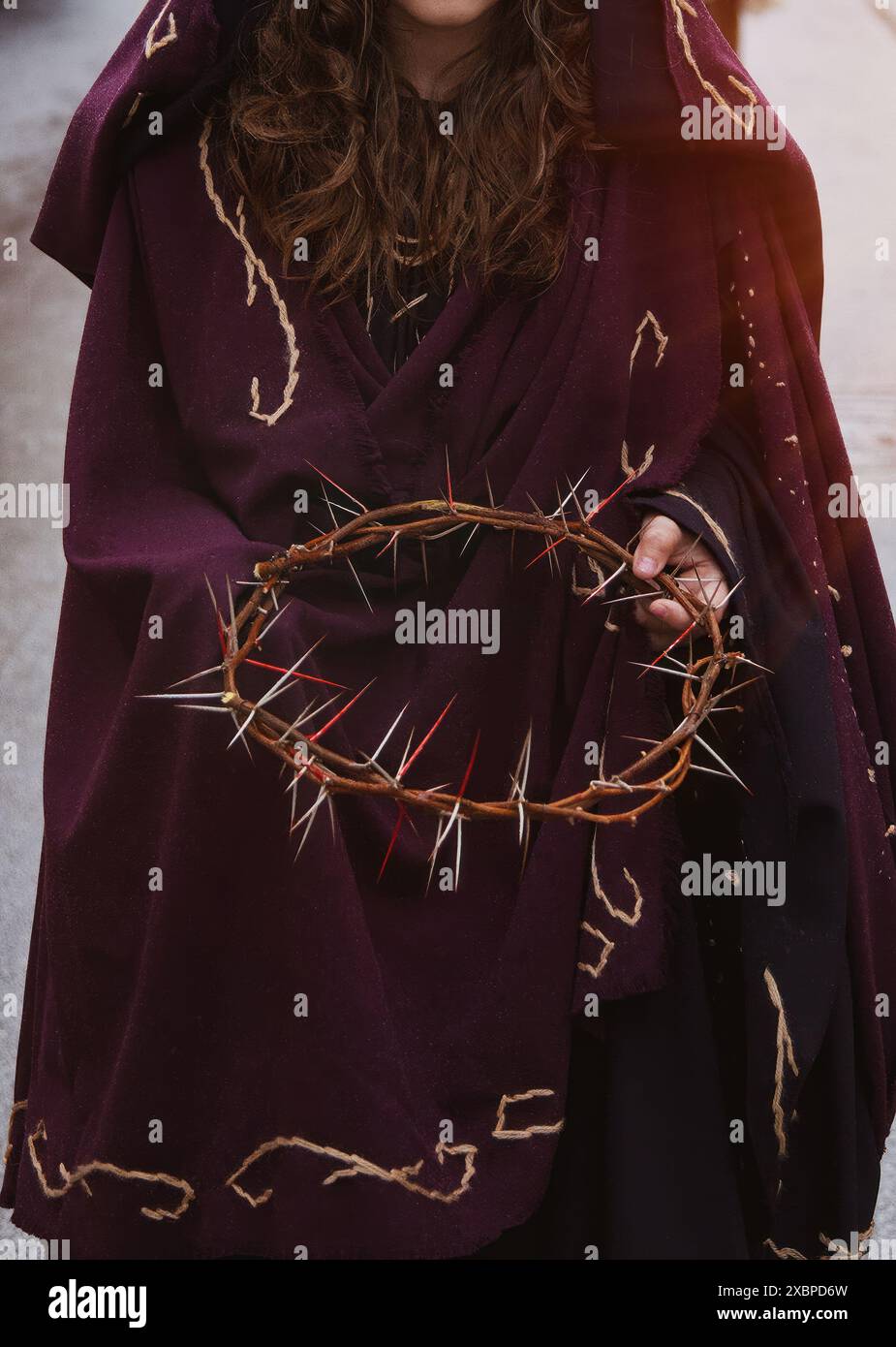 Woman wearing a purple robe holds a crown of thorns, representing faith ...