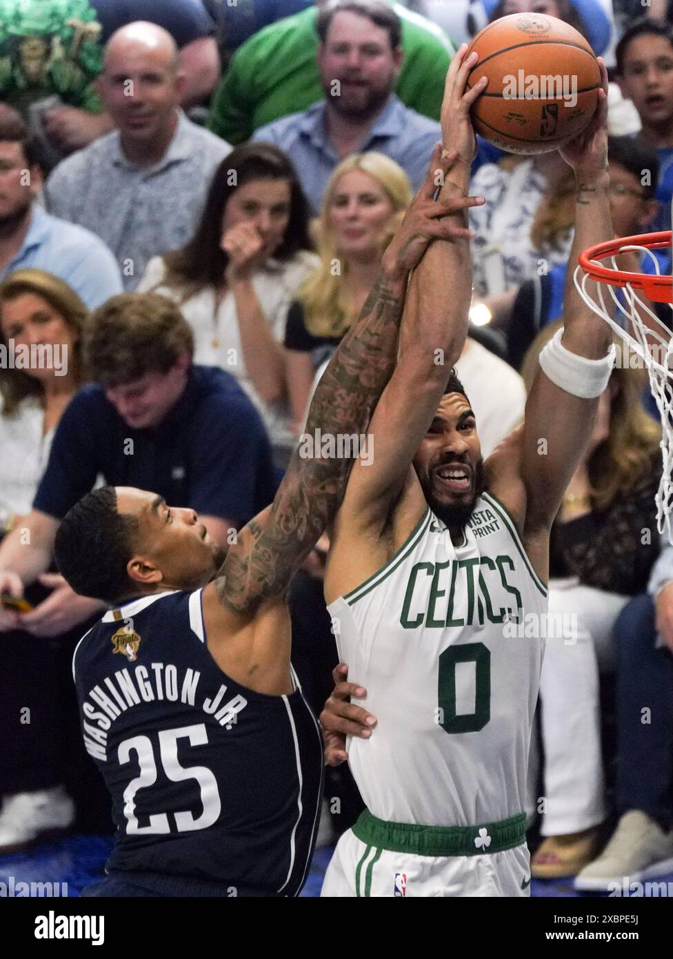 Dallas, USA. 12th June, 2024. Jayson Tatum (R) of Boston Celtics dunks ...