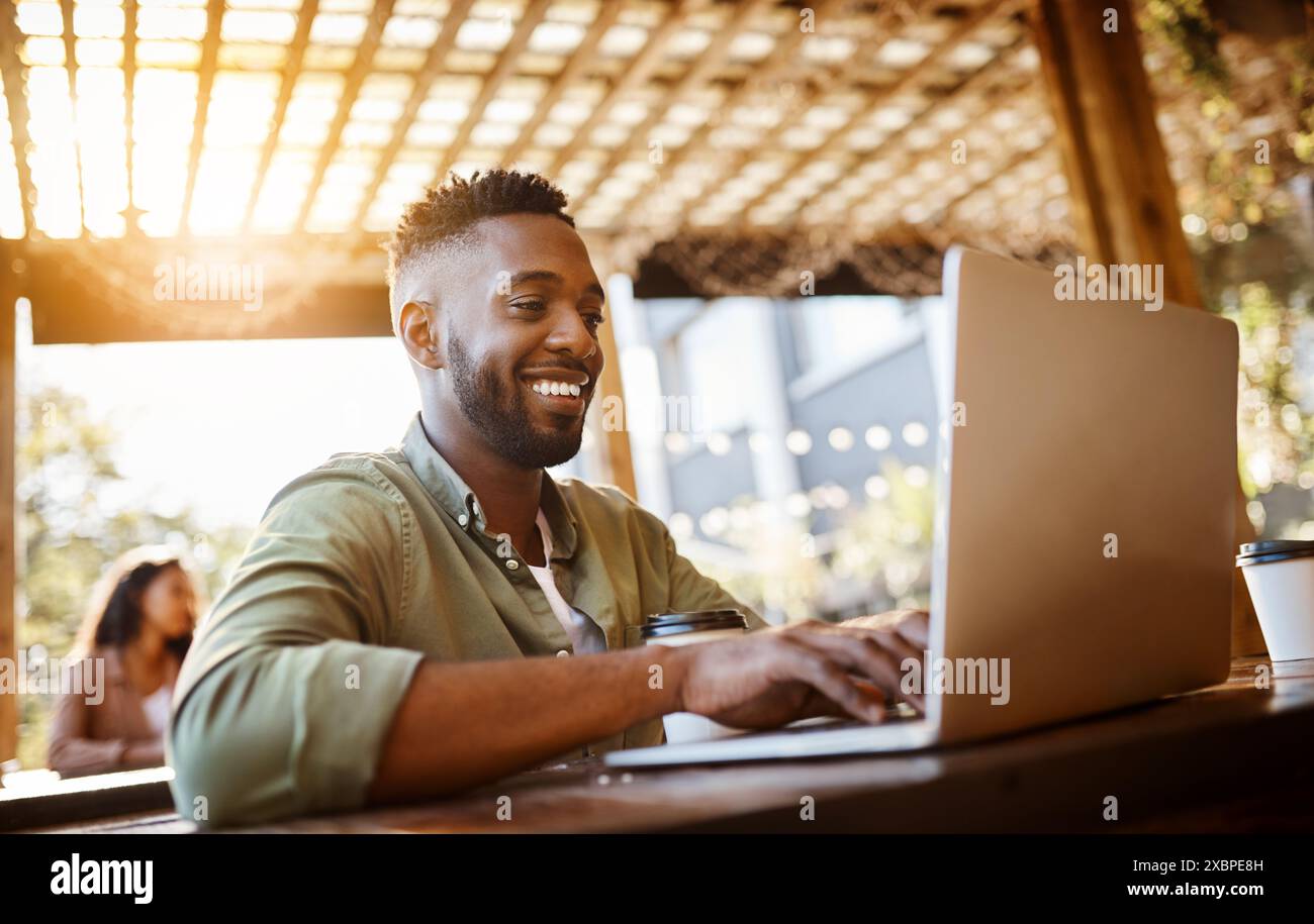 Smile, black man and laptop for typing in cafe with social media update ...