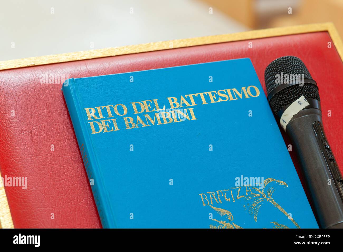 Children's baptism rite captured in a blue book on a red velvet pulpit ...