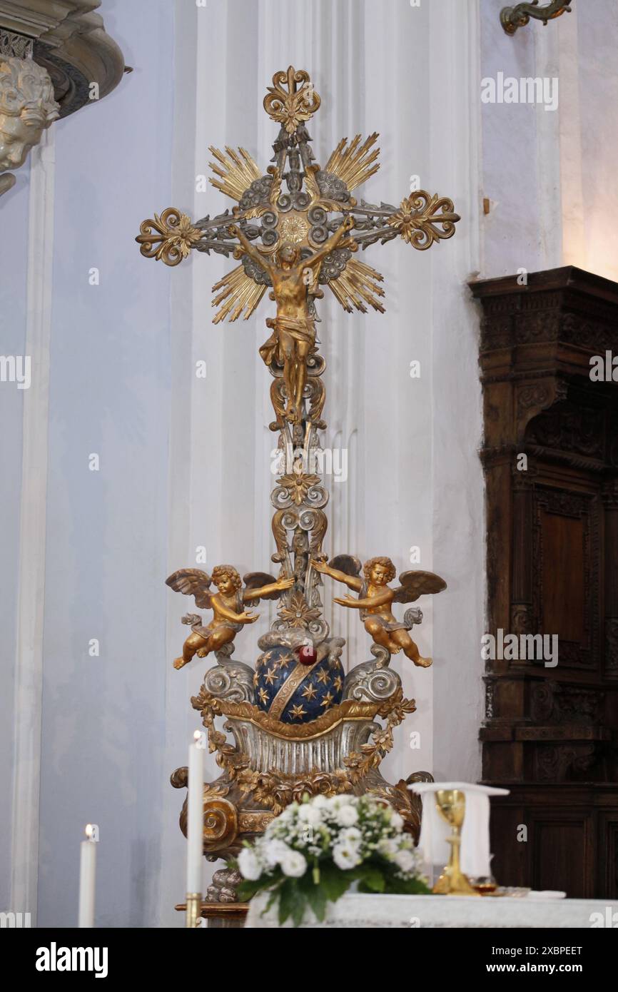 Golden crucifix and angelic adornments embellishing a church ...