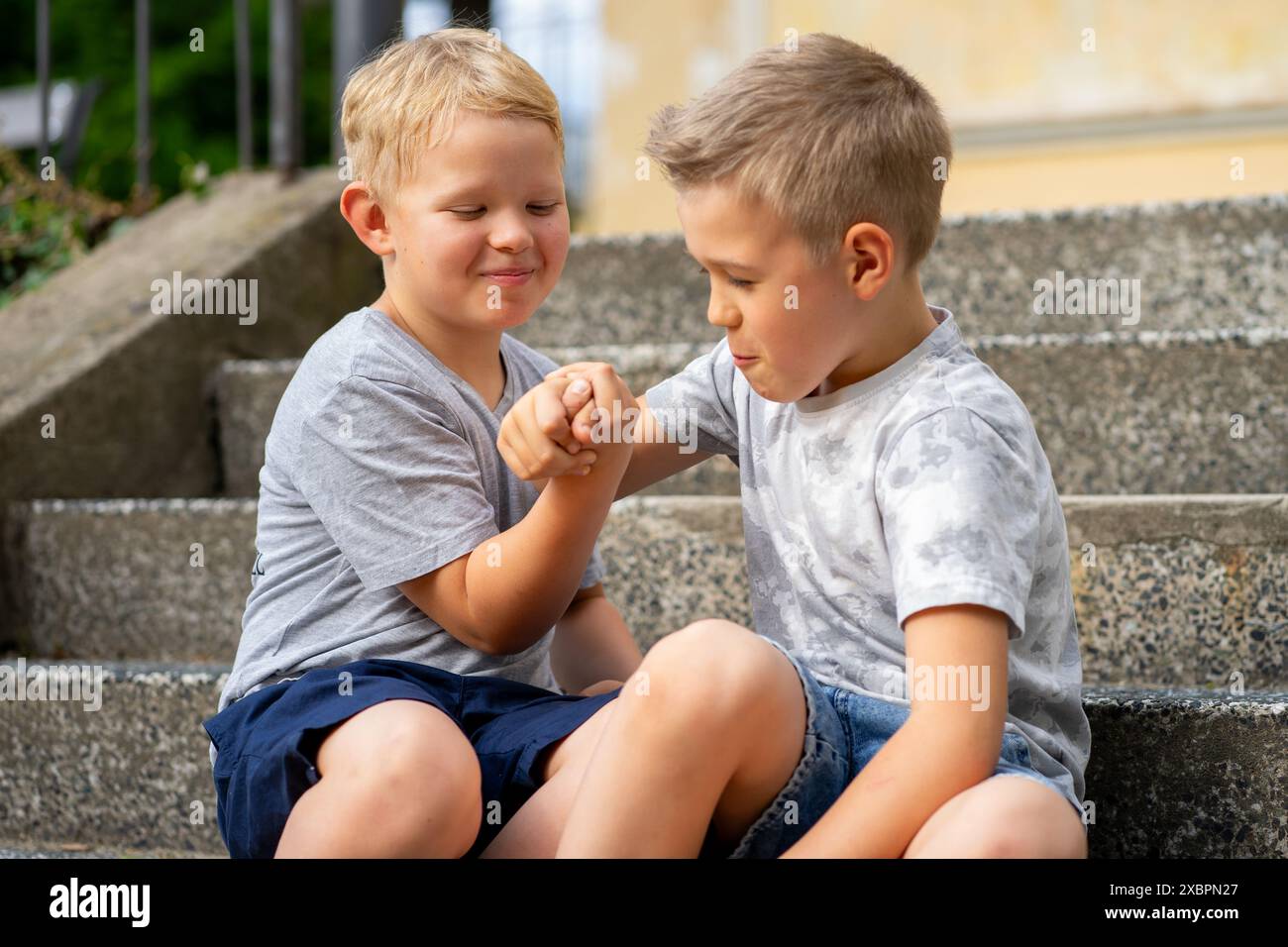 Two kids as friends fighting with each other for fun Stock Photo - Alamy