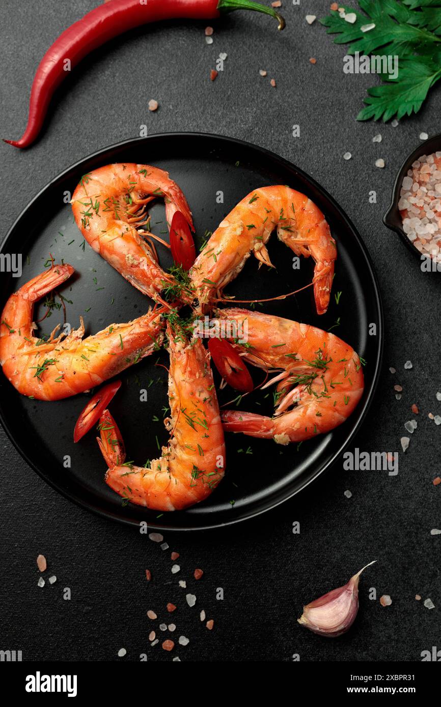 Large cooked king prawns on a black background. Lemon slices Stock ...