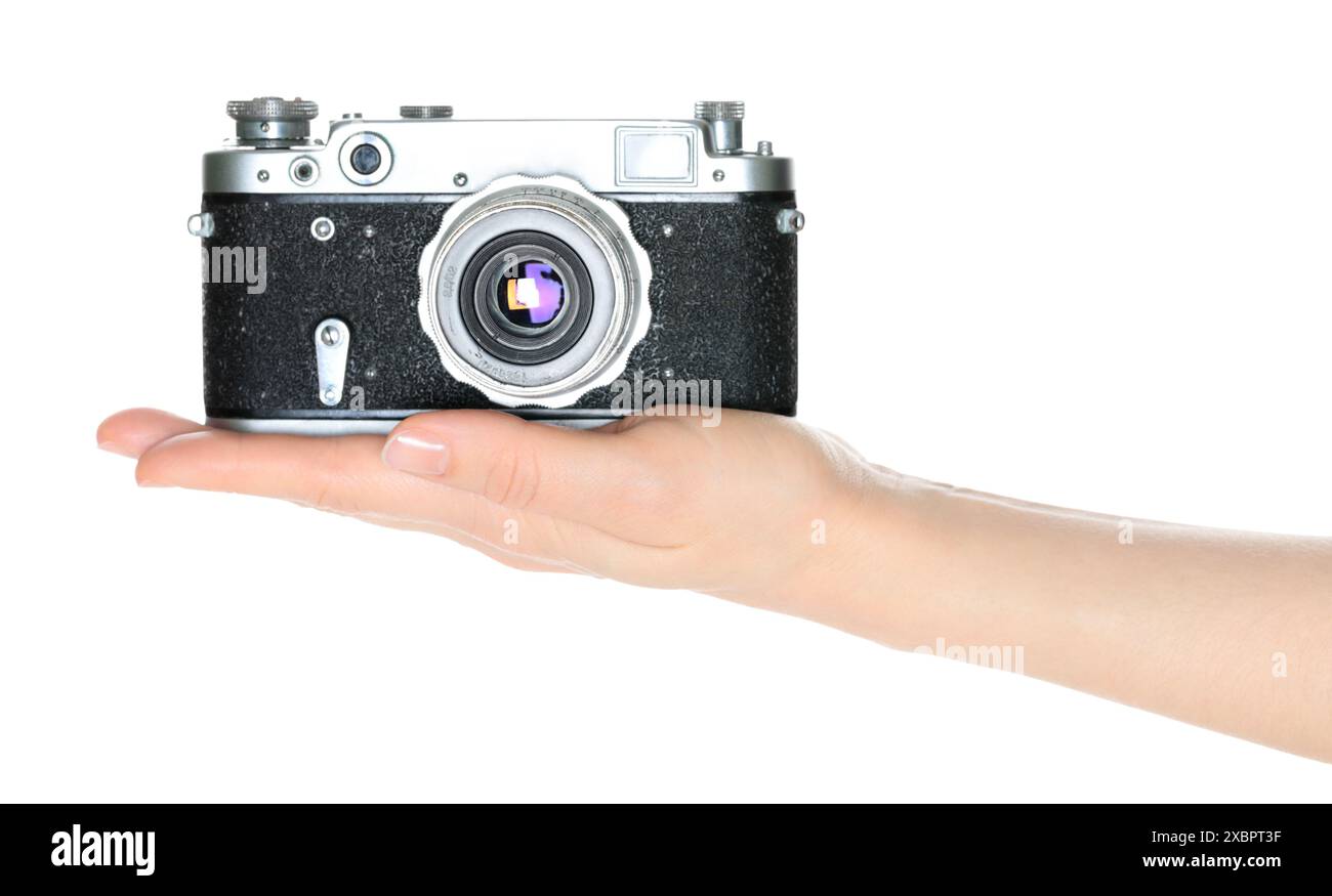 Women hand holding retro photo camera, isolated on a white background ...