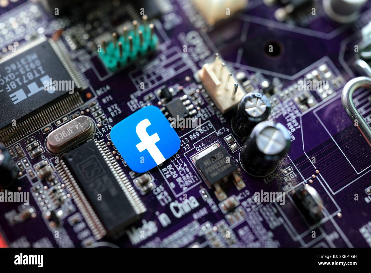 Facebook icon on a computer motherboard close-up, social media and ...