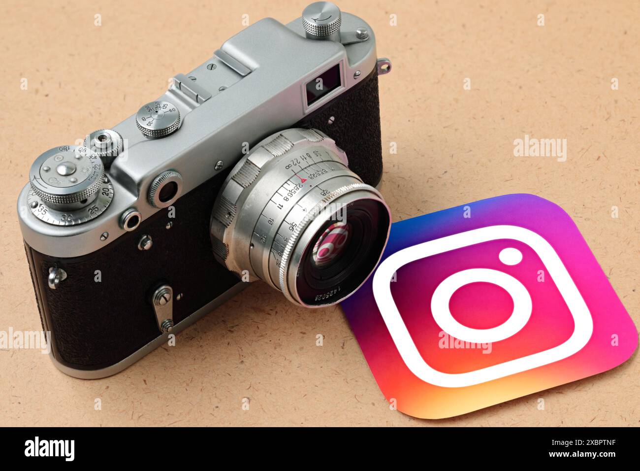 Retro photo camera with Instagram app icon, on old paper background ...