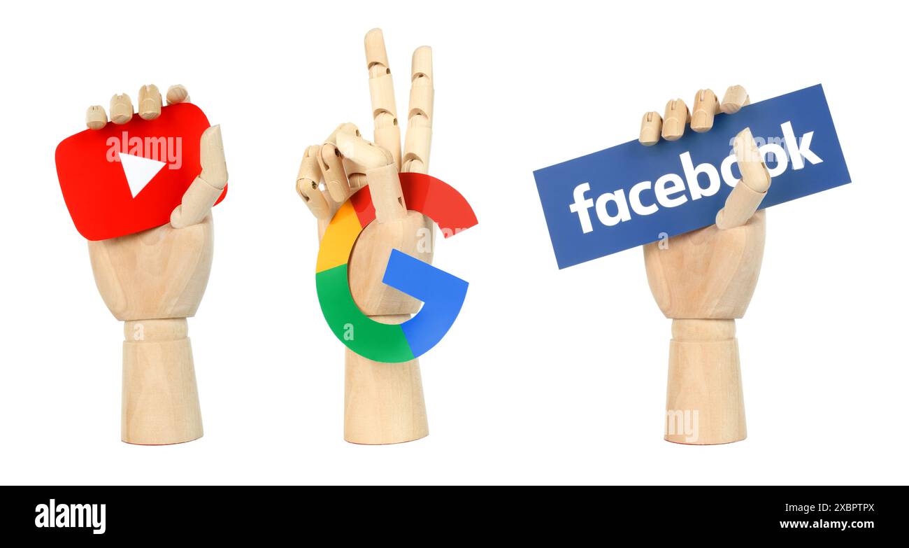 Set of Wooden hands holding YouTube, Google and Facebook logos, on a ...