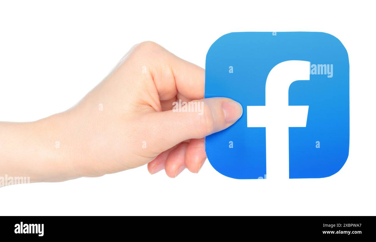 Hand holds paper Facebook mobile app icon, on a transparent background ...