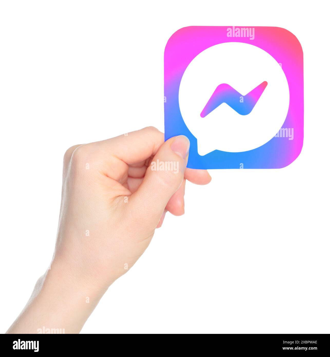 Hand holds paper Facebook Messenger mobile app icon, on a transparent ...