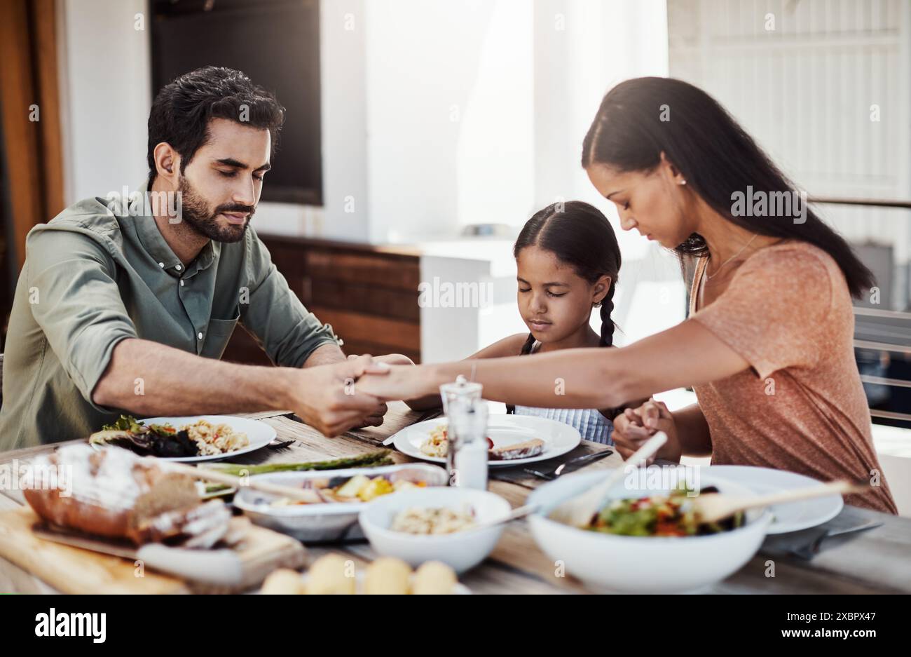Worship, family and food at table for faith, gratitude and praying ...