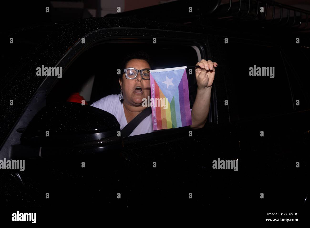 San Juan, USA. 12th June, 2024. A woman waves the Puerto Rican LGBTQ ...