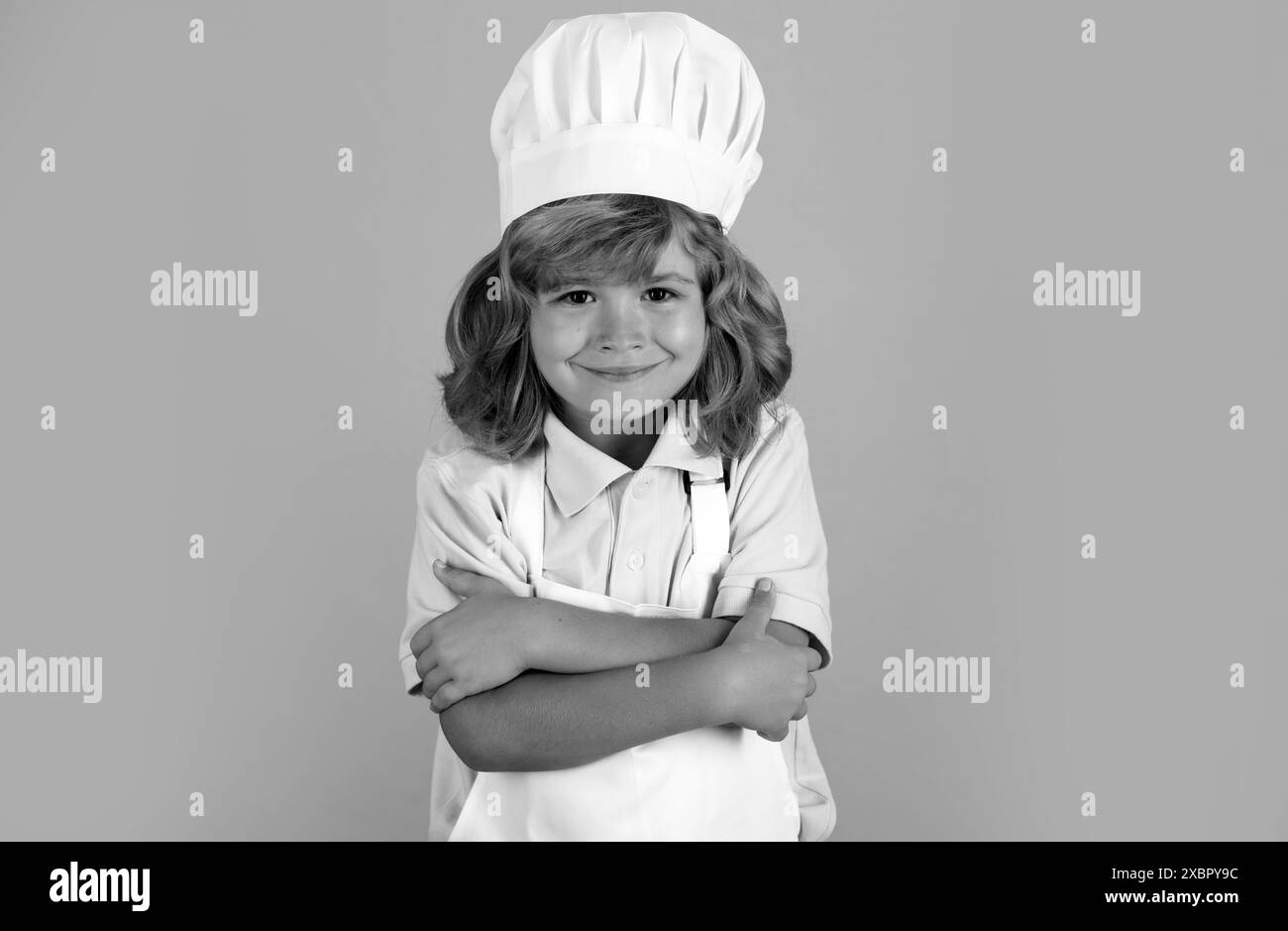 Portrait of child chef isolated on blue. Funny little kid chef cook ...